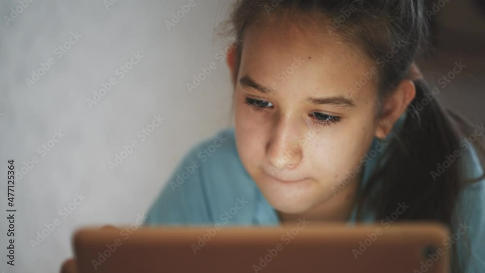 Kid child girl holding digital tablet. Teenager learning at home. Child ...