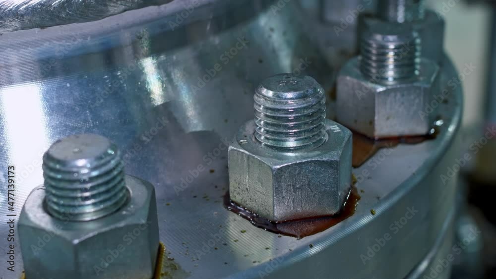 Close-up of pipeline flange connections screwed onto a bolted ...