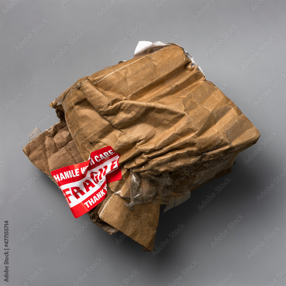 Fragile handle with care sticker on crushed package Stock Photo | Adobe ...