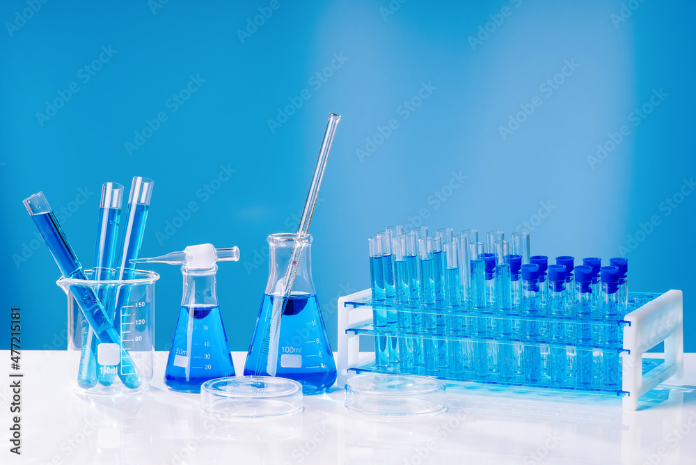 Collection of medical flasks on a blue background.Science glass flask ...