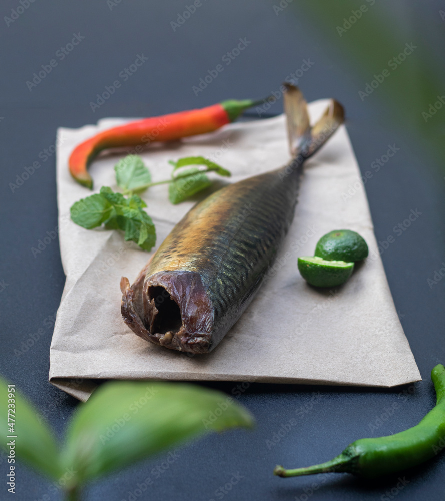smoked mackerel fish with spices on dark stone background. Smoked fish ...