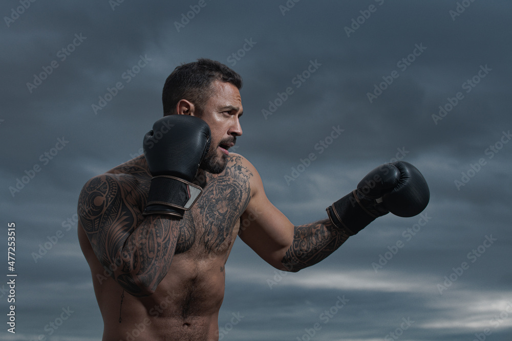 Boxer fighter training outdoors. Sportsman muay thai boxer fighting in ...