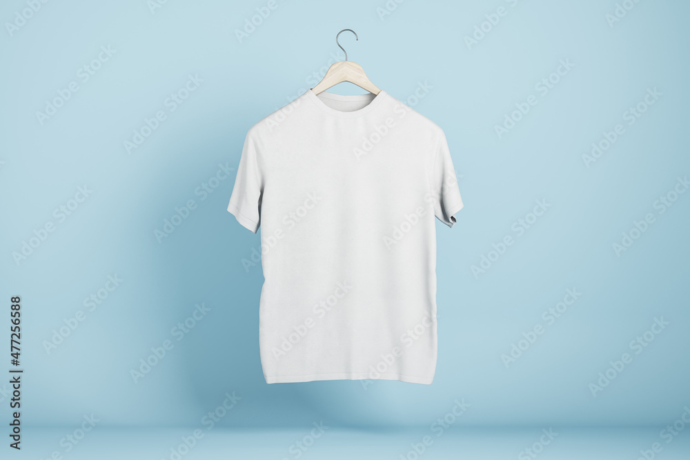Empty white tshirt hanging on blue wall background. Product design and ...