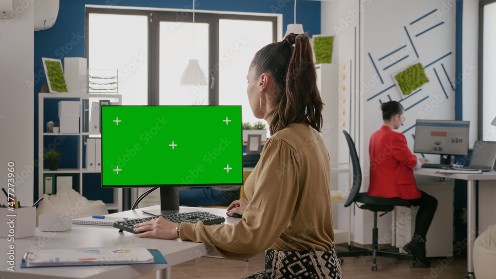 Adult working on computer with green screen in business office. Woman ...