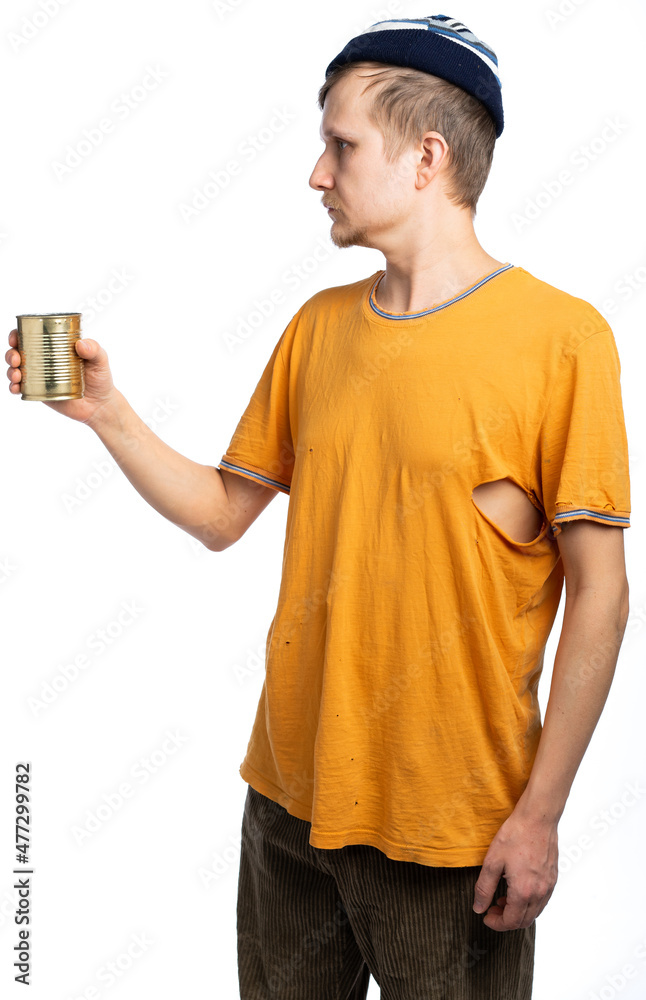 a homeless man looks away, holds a can of canned food, an orange torn T ...