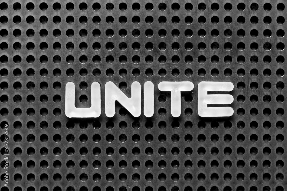 White alphabet letter in word unite on black pegboard background Stock ...
