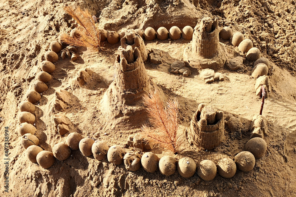 Foto de Sand castle, fortress on a hot sunny day. Summer vacation with ...
