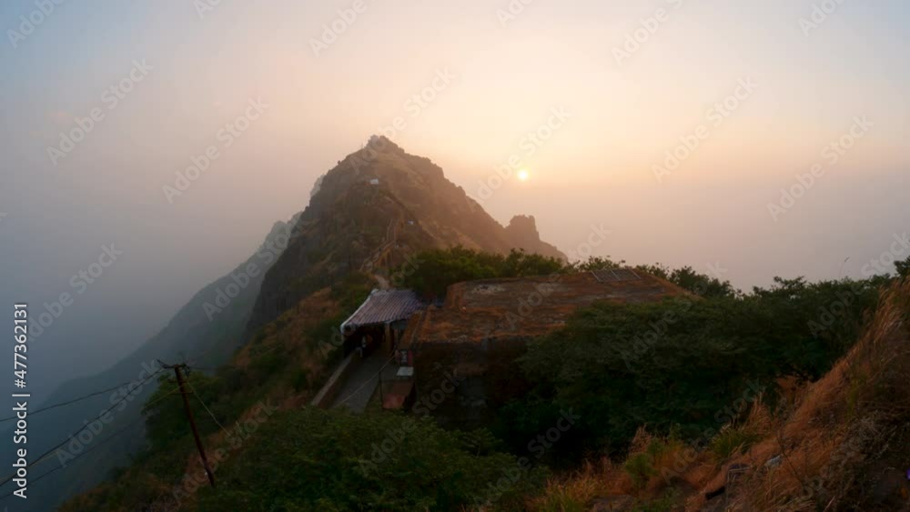 4K time lapse of a sunrise over Girnar mountain. Beautiful winter morning landscape background ...