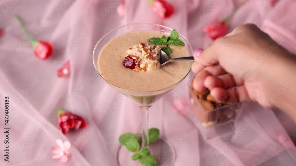 Kesar Badam milk shake Almond Saffron milk woman hand serving smoothie ...