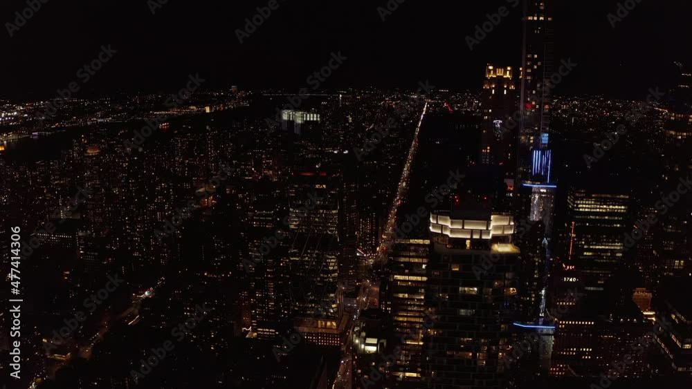 Fly above night city. Modern tall downtown buildings. Lighted windows ...