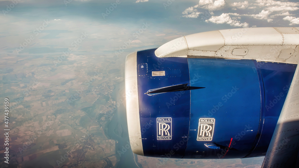 Rolls Royce logo on an airplane engine, flying above clouds Stock Photo ...