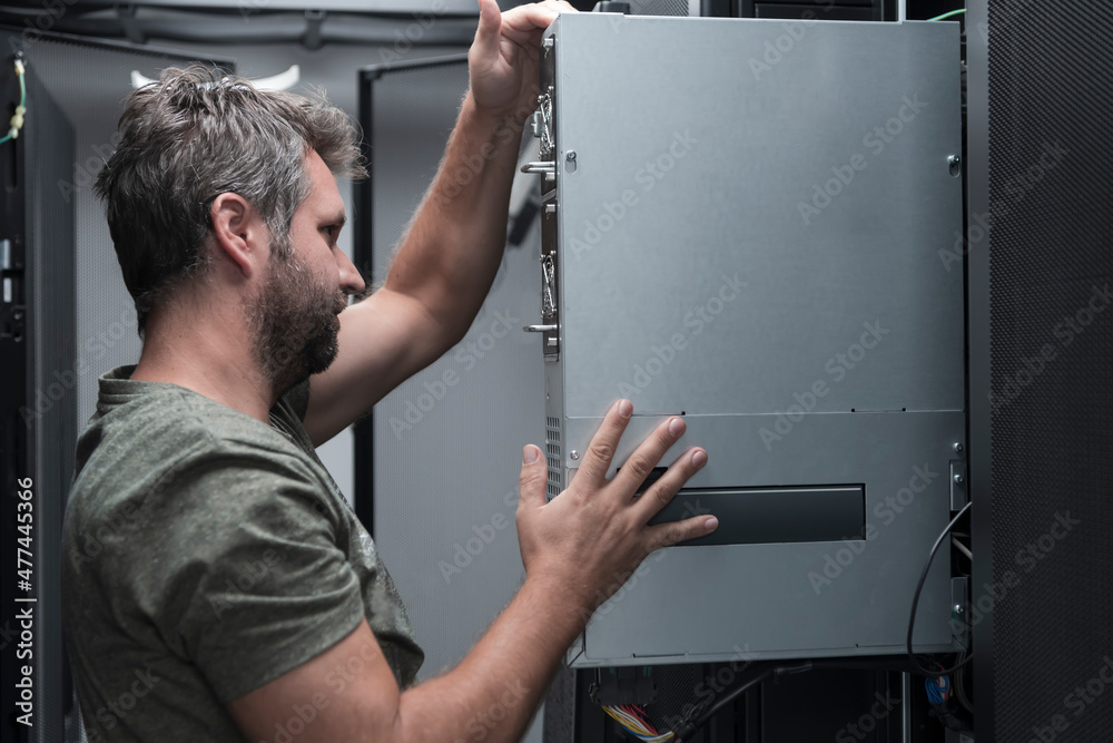 IT engineer working In the server room or data center The technician ...