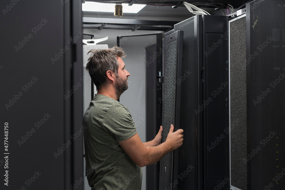IT engineer working In the server room or data center The technician ...
