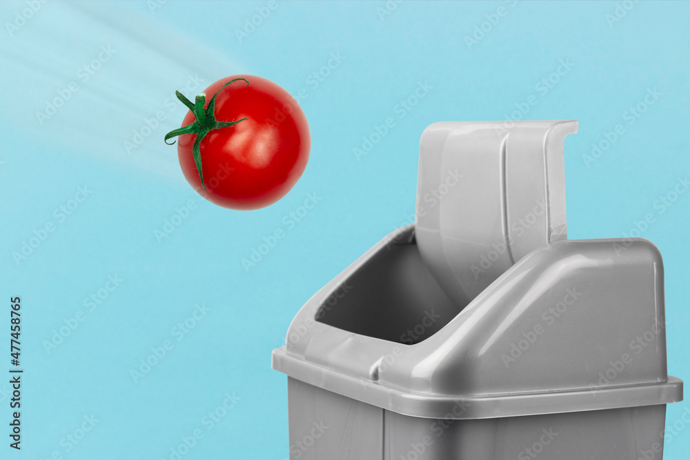 red tomato goes in the trash, giving up vegan food Stock Photo | Adobe ...