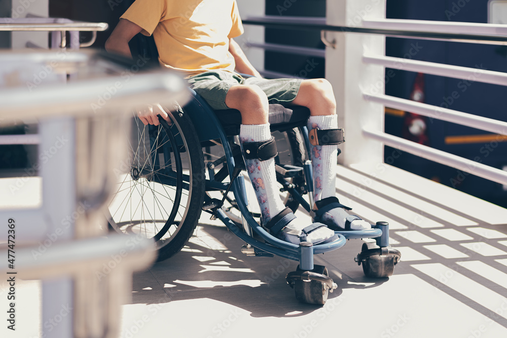 Young man with disability with using wheelchair by himself on public ...