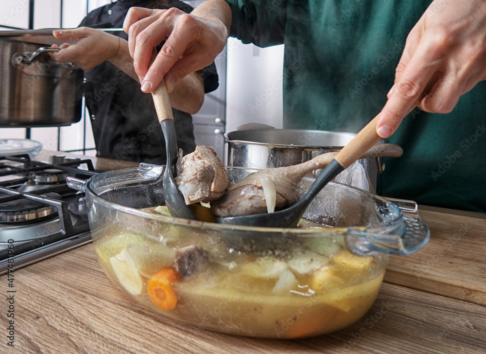 Frying pan on a gas stove. Chef controls the cooking process. cooking ...