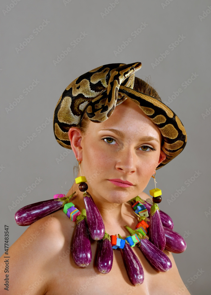 A beautiful young woman poses nude for the camera. Her jewelry is made ...