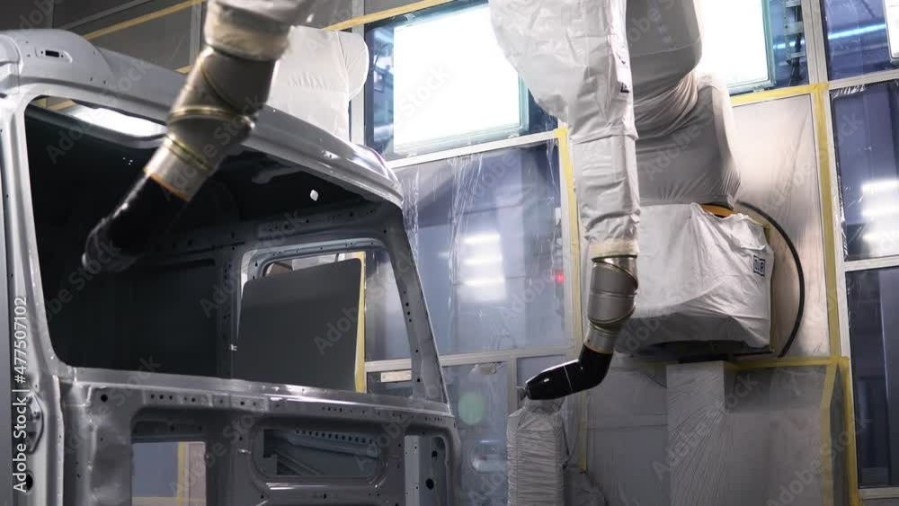 Robotic technology paints body of car. Scene. Robotic hands paint car ...