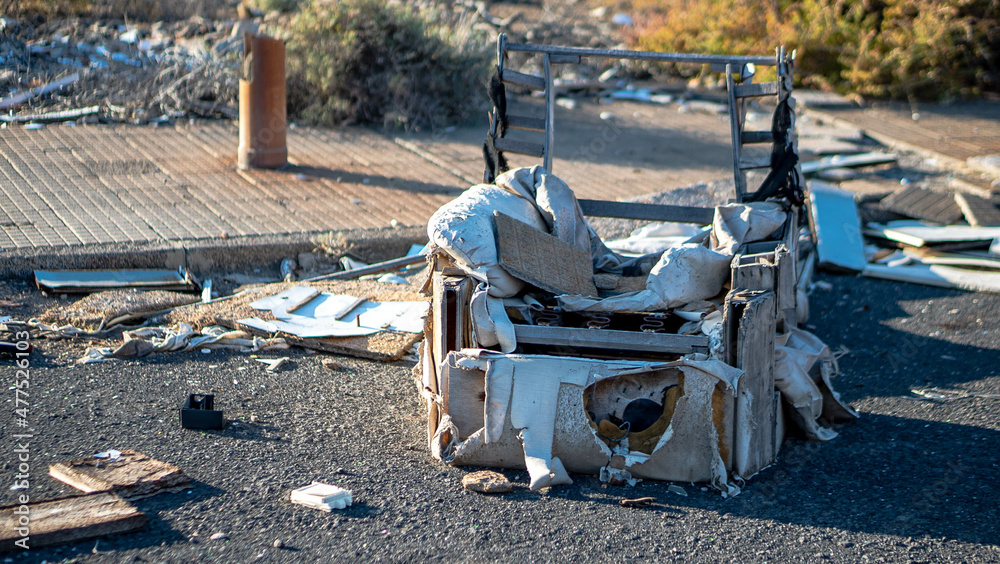 rubble and garbage thrown and abandoned on the street in a vacant lot ...