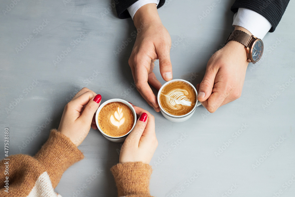 two people talking while drinking coffee. Stock Photo | Adobe Stock