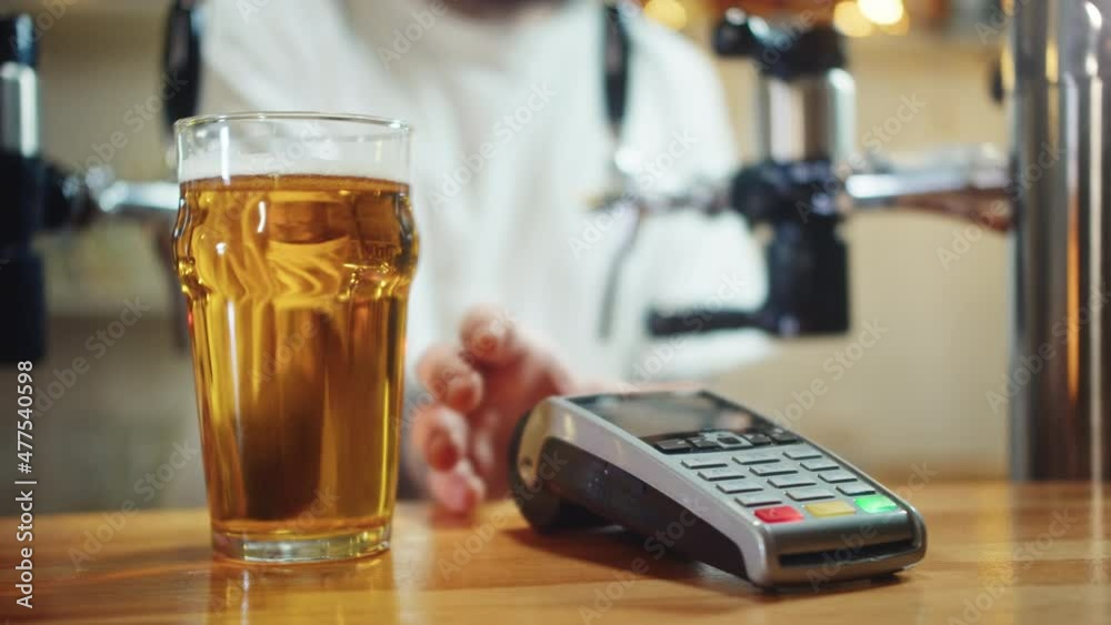 Buying beer and paying by phone with blue screen chroma key close-up ...