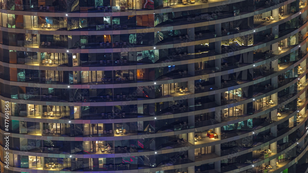 Outside view of windows in apartments of a high class building at night ...