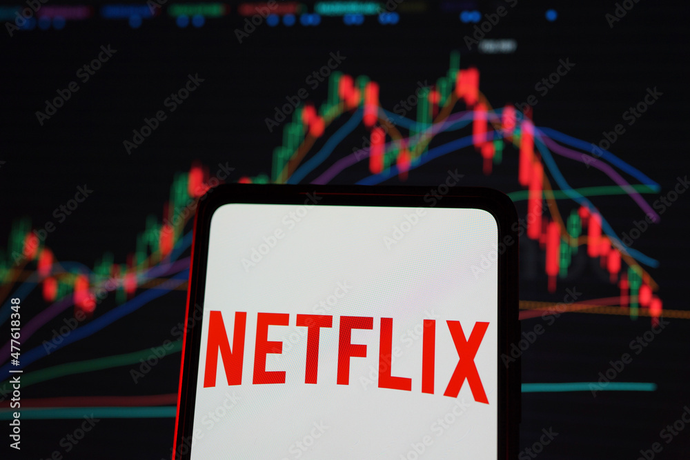 Netflix logo and stock index is seen on display screen. It is an ...