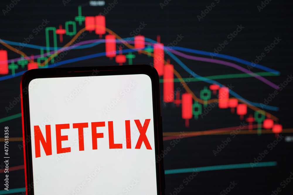 Netflix logo and stock index is seen on display screen. It is an ...