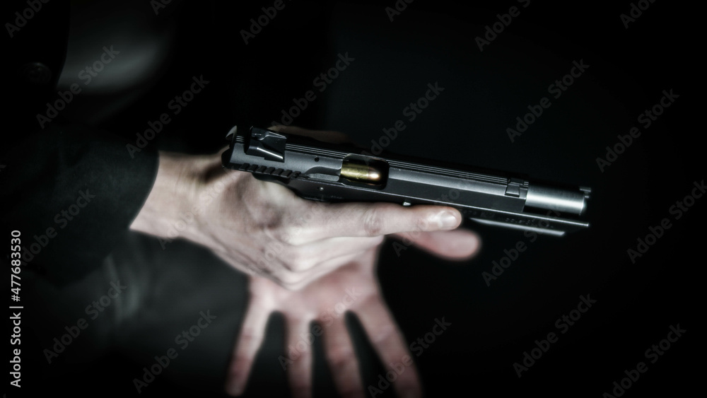 Man loading a 9mm pistol. Personal defense and concealed carry concept ...