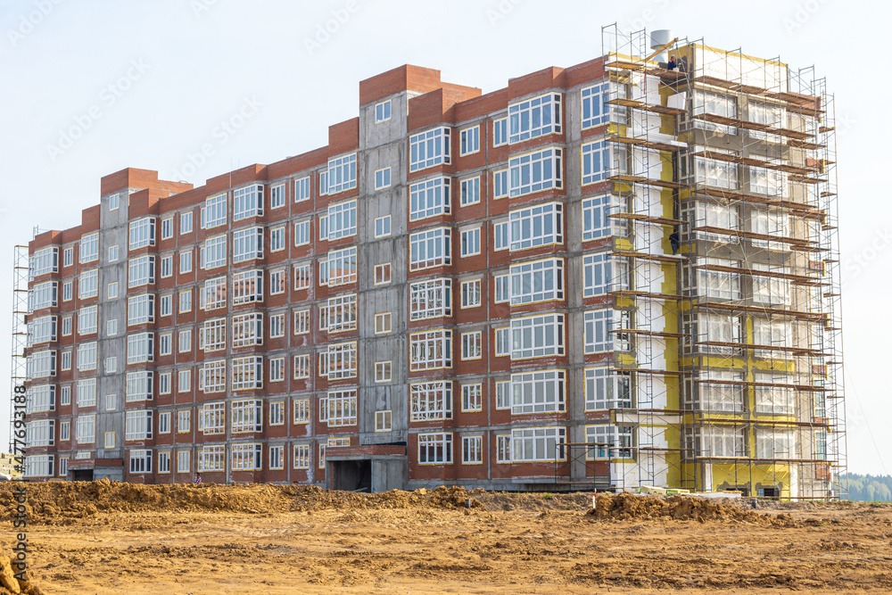 the construction of a residential building is nearing completion ...