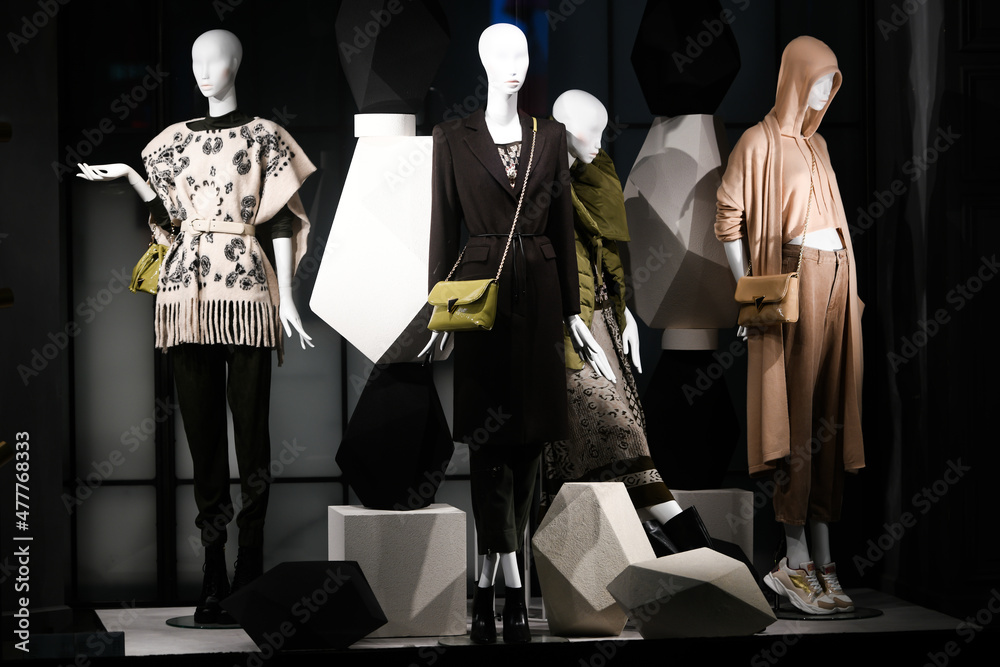 Mannequins standing in a window display of a clothing store. Stock ...