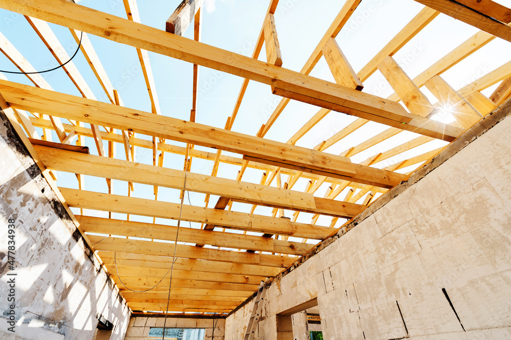 Construction of the roof frame of a small house. The wooden structure ...