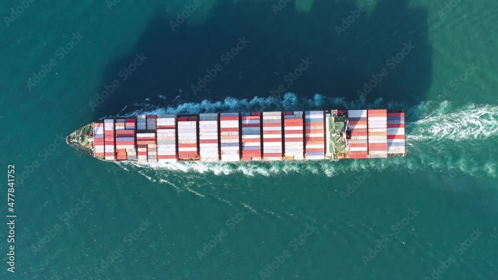 Aerial top view of smart cargo ship carrying container and running very ...