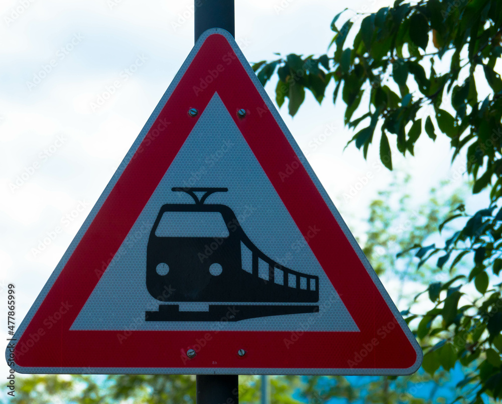 Typical european railroad crossing sign on a country road, pointing to ...