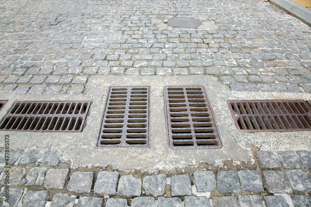 cobbleston granite stone road with drain grates for storm water ...