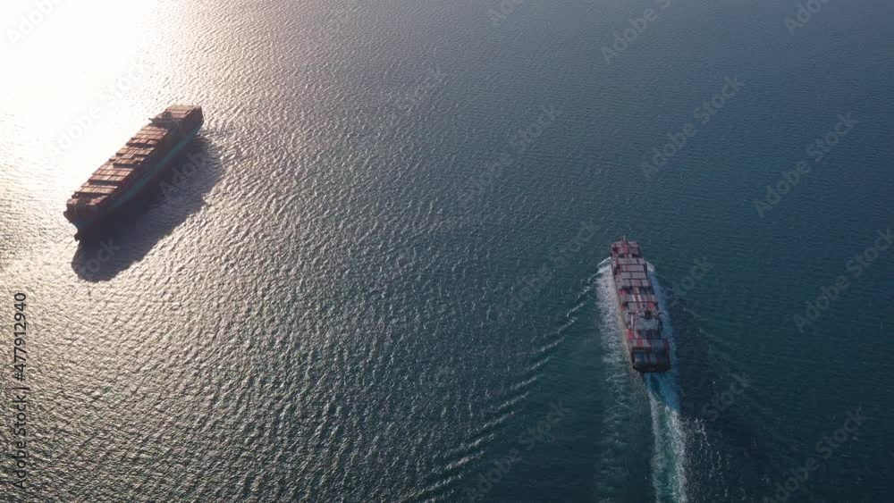Aerial side view of smart cargo ship carrying container from custom ...