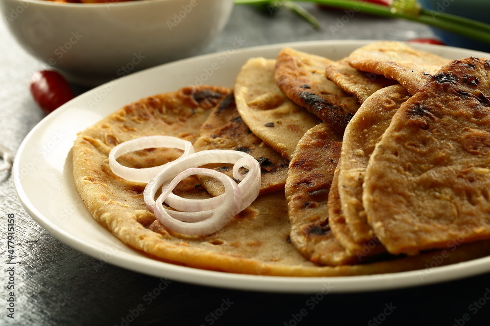 North Indian wholesome meal- traditional aloo paratha with fresh raita ...