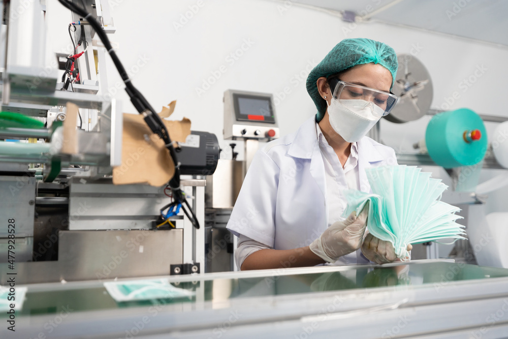 woman factory worker are producing medical face masks, counting and ...