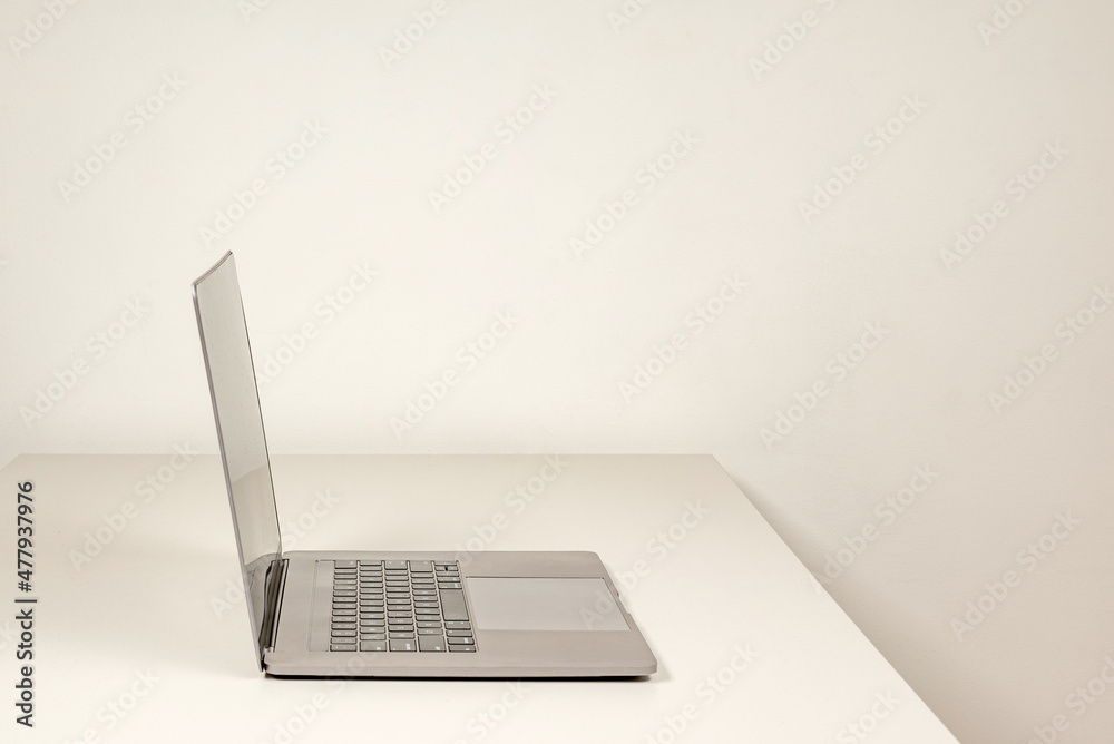 Foto de silver laptop PC side view on desk in office room do Stock ...