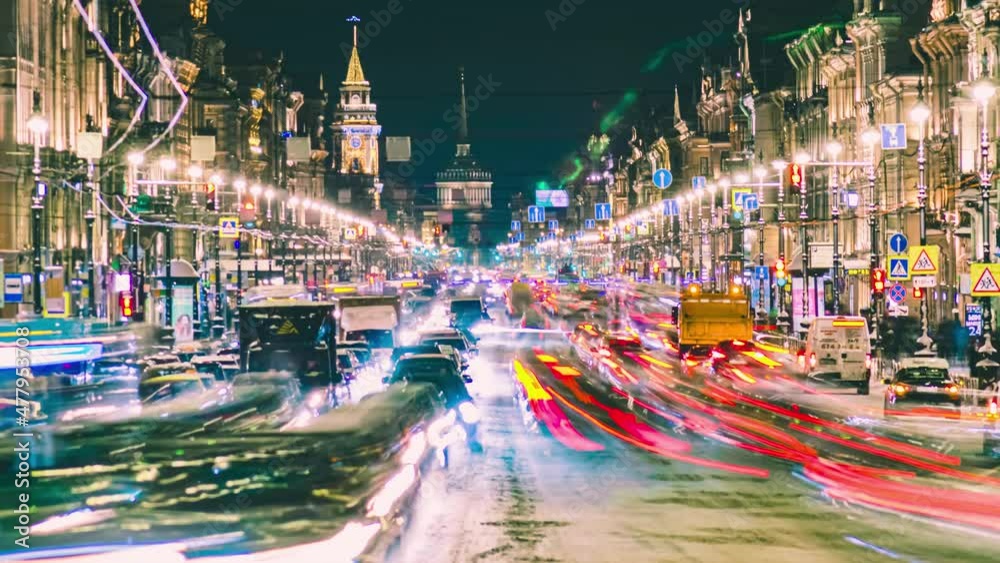 Night city traffic on busy street with buildings on sides of marked ...