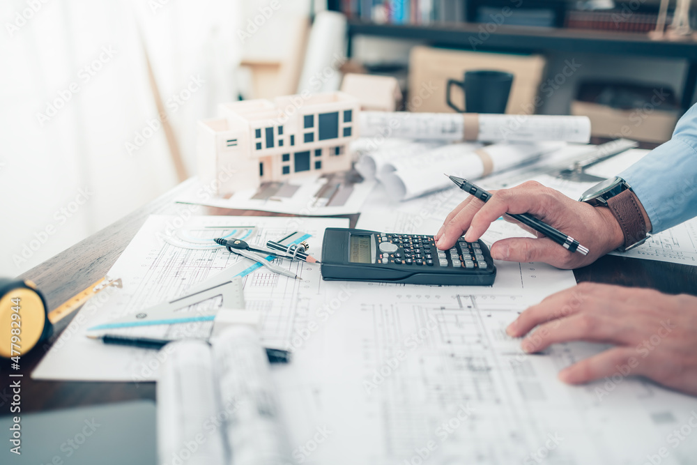 Architect engineer use calculator for calculate drawing design working ...