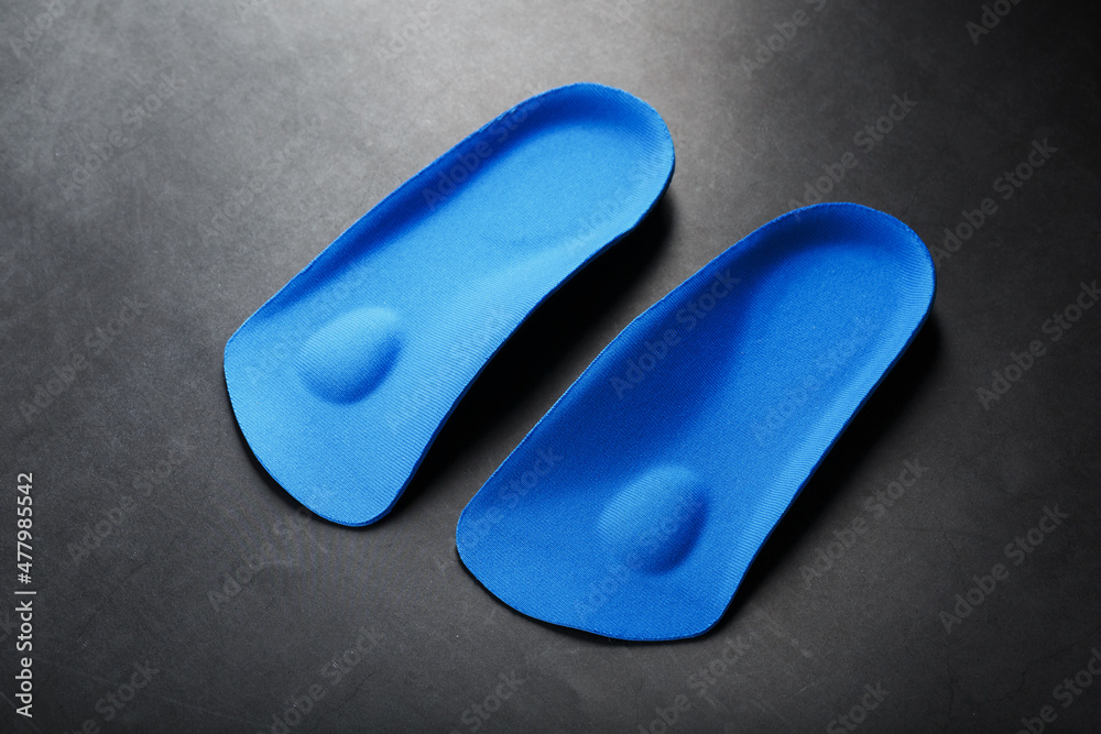 Orthopedic insoles for correction of pronation of the foot on a dark ...