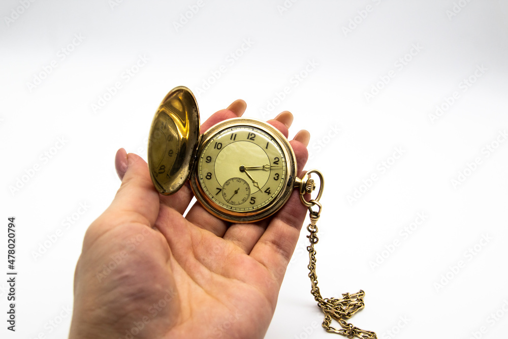 Vintage golden old pocket watch on the hand against white background ...