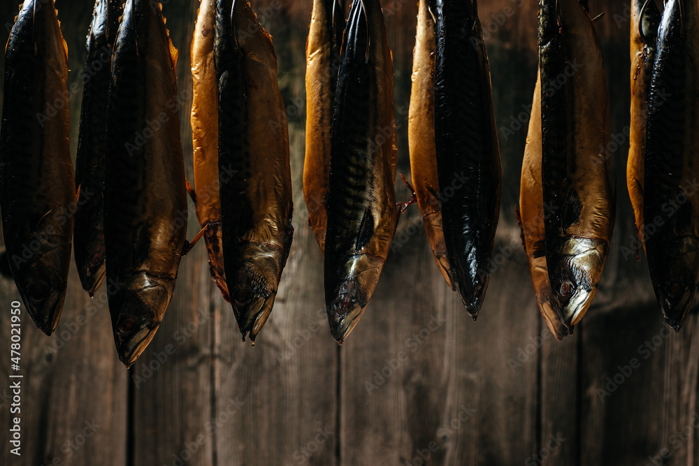 Smoked fish in smokehouse. Smoking Process Fish. Smoking fish hanging ...