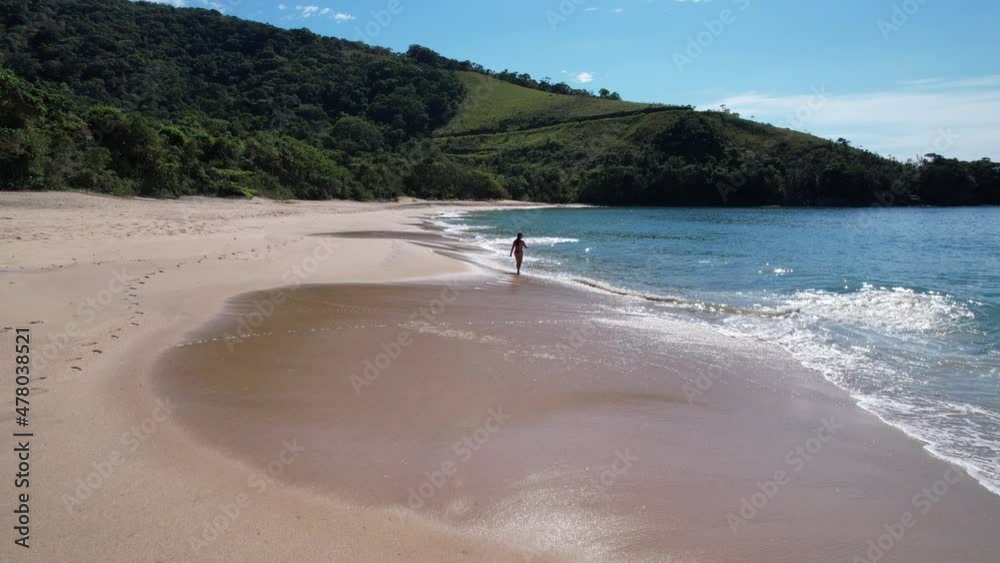 Brazilian woman in bikini on a deserted beach in Ubatuba, São Paulo ...