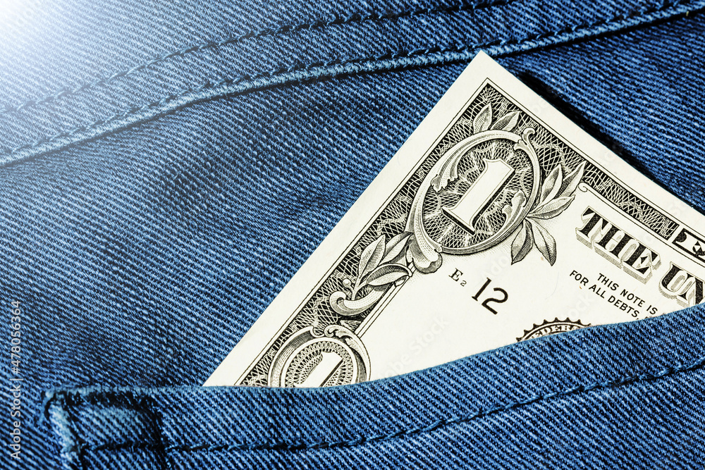 Pocket money background. One dollar bill. Money in blue jeans trousers ...