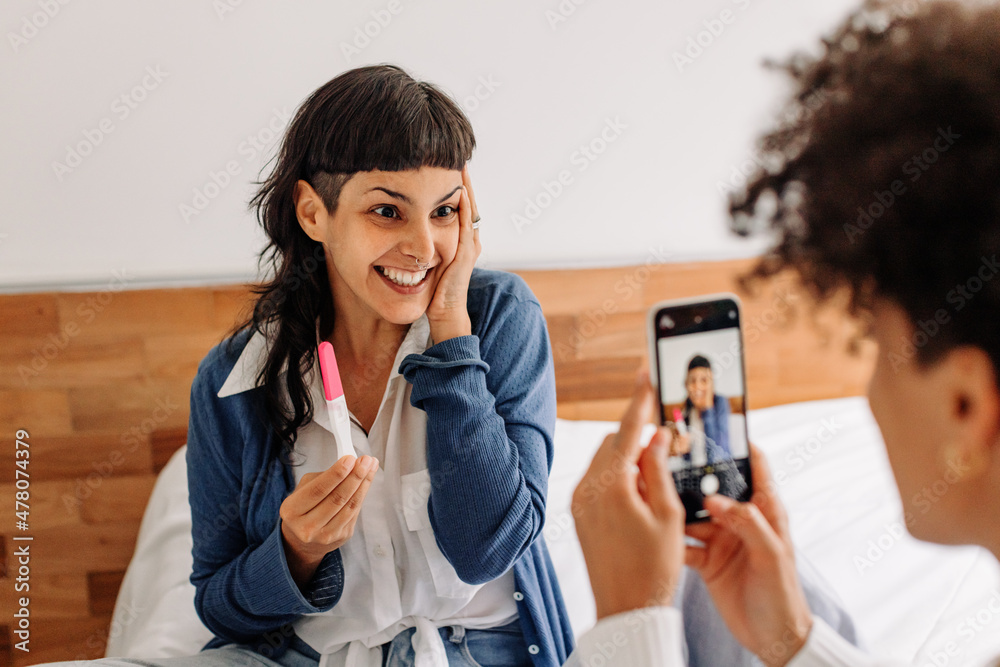 Young woman posing for a picture holding her pregnancy test Stock Photo ...