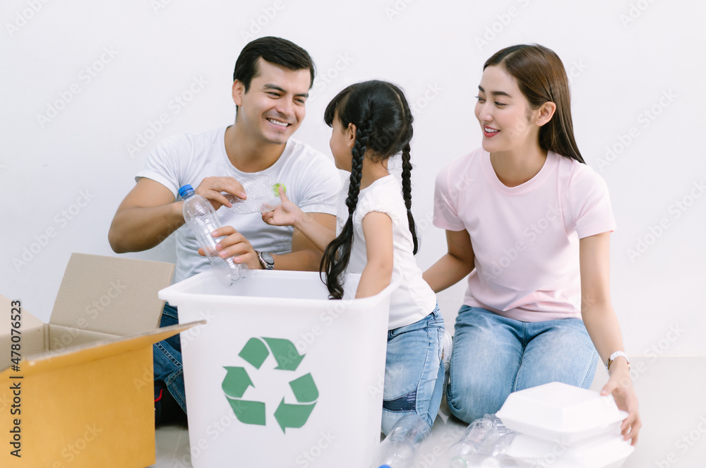 Happy Asian family separating sorting trash for further recycling near ...