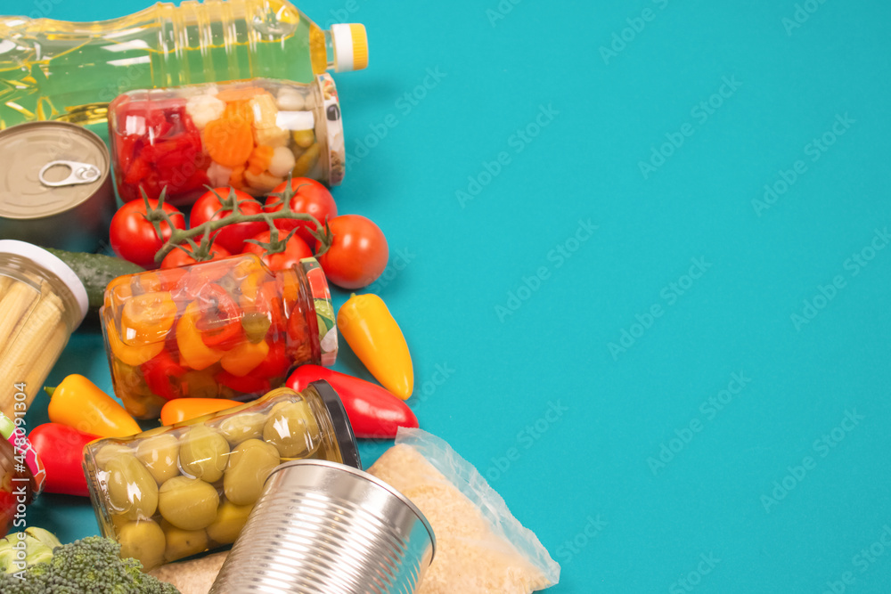 Food donations and different groceries on blue background with copy ...