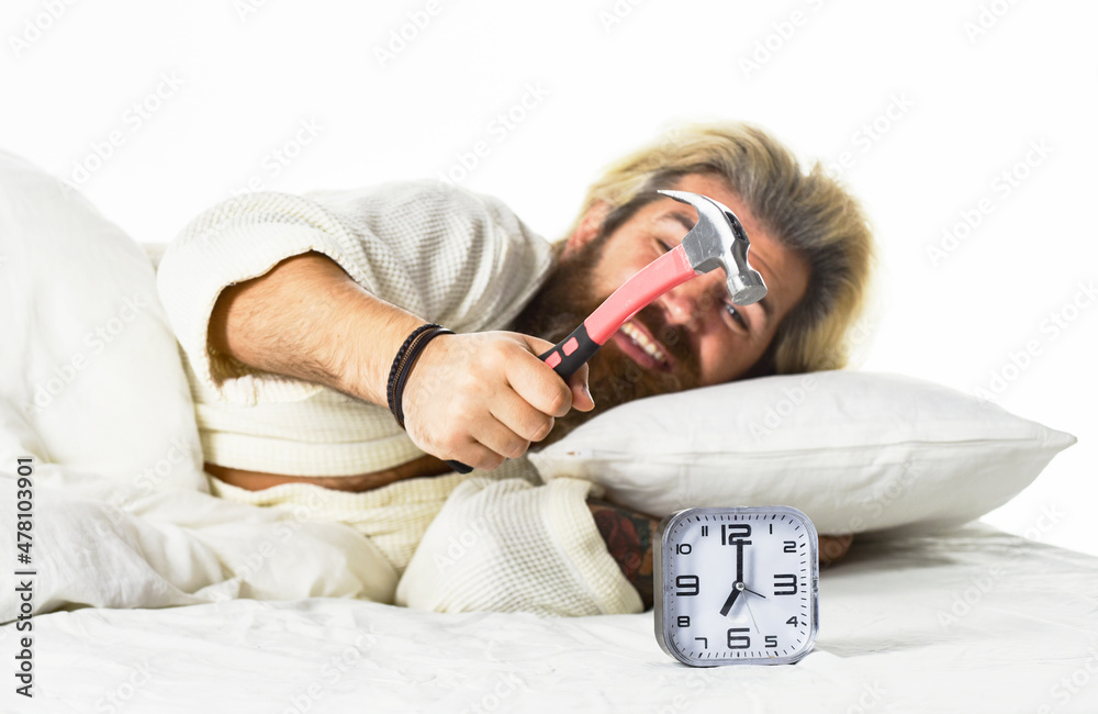 asleep and awake. handsome angry man lies in bed indoors wake up turn ...